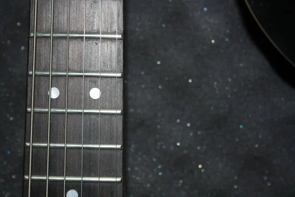 Guitar strings, light wood guitar body. Space for text. - Stock Image ...