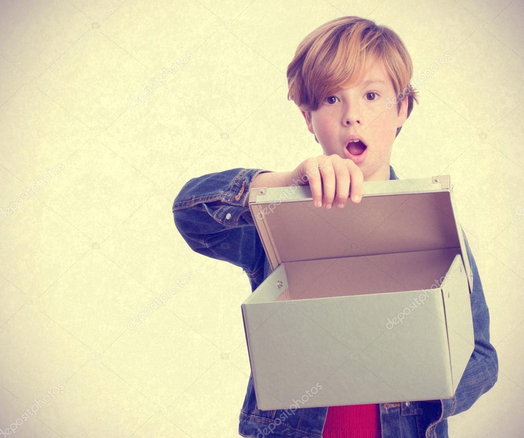 Surprised child opening a box Stock Photo by ©kues 65701395