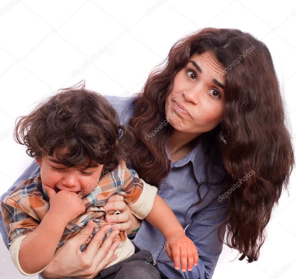 Concerned mom holding her angry son Stock Photo by ©kues 65704239
