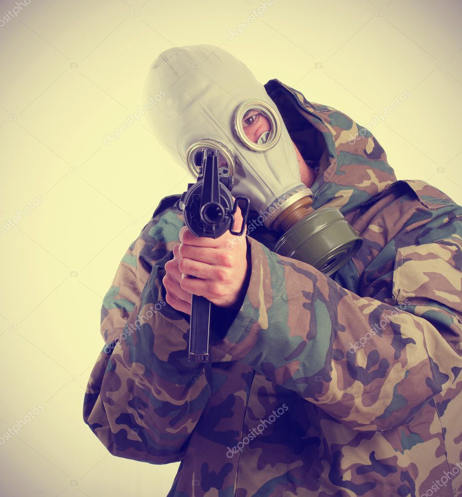 Militar with a rifle and a gas mask Stock Photo by ©kues 65961485
