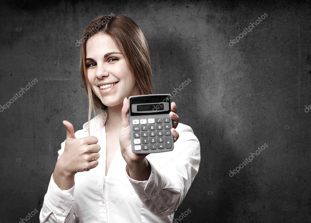 Blond woman with calculator Stock Photo by ©kues 75057819