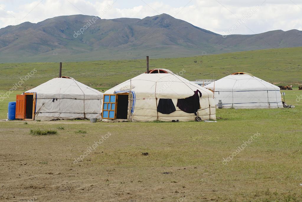 Three traditional Mongolian yurts (nomadic tents) located in steppe ...