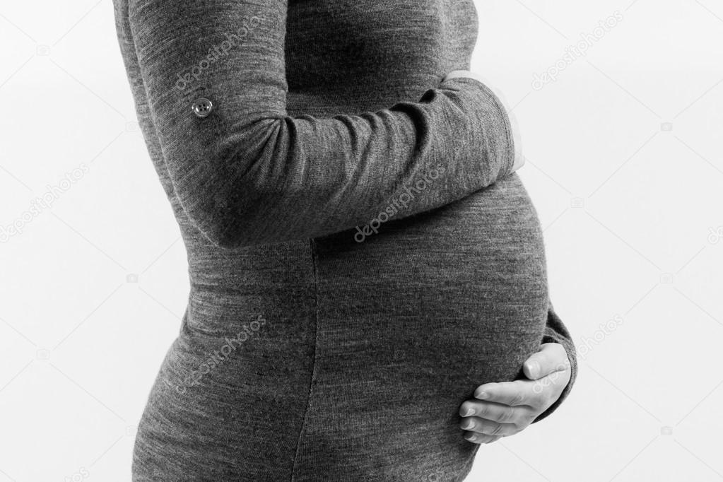 Image Of Pregnant Woman Touching Her Belly With Hands Side View On