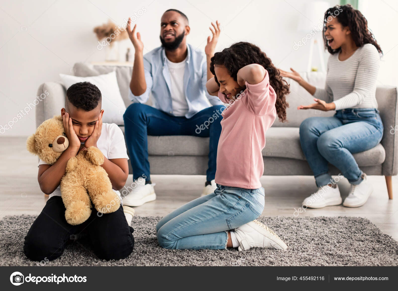 Sad children with their fighting parents in the background Stock Photo ...