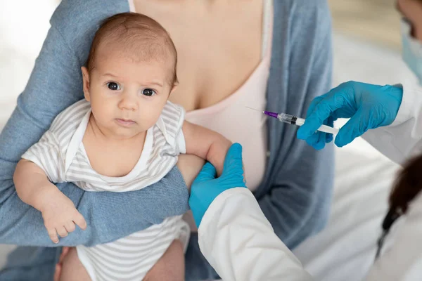 Doctor giving intramuscular injection to little baby — Stock Photo ...