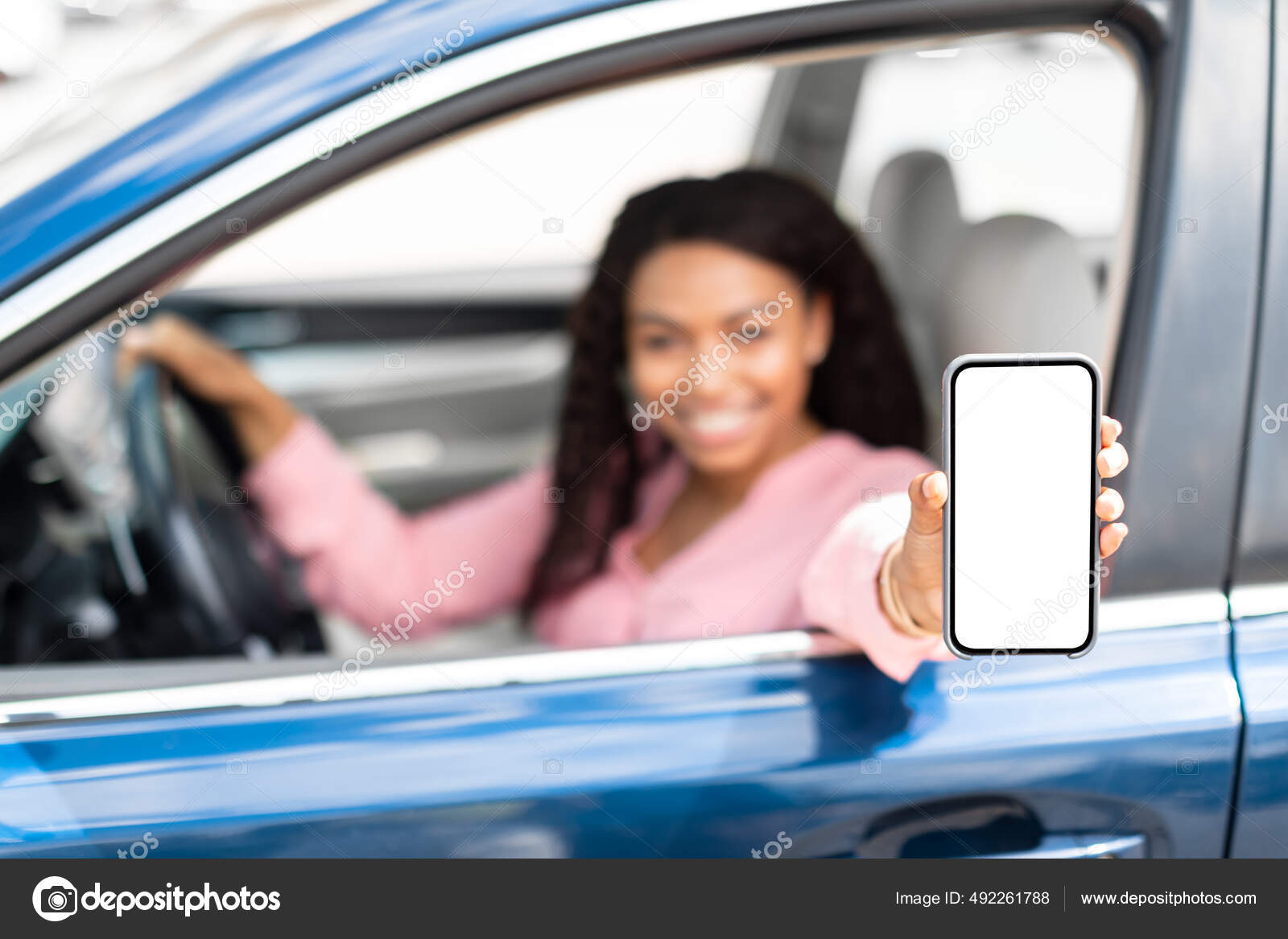 Happy black driver using showing smartphone with empty screen — Stock ...