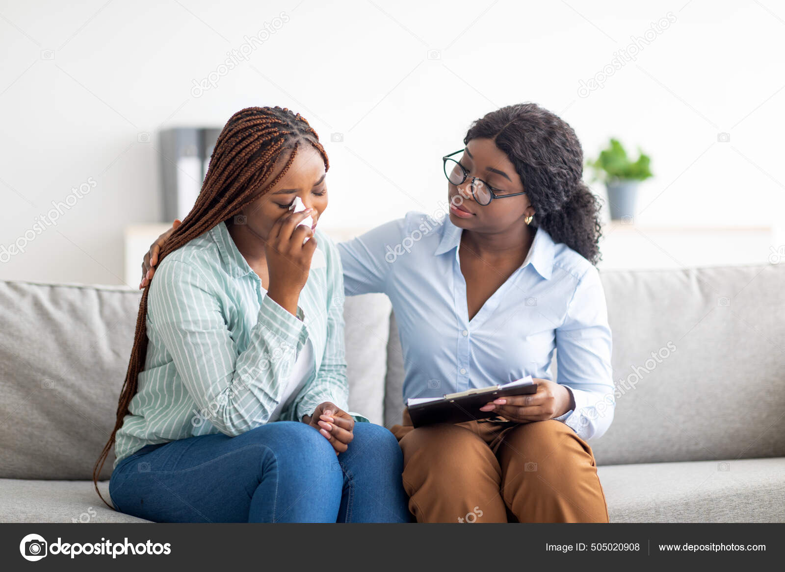 Compassionate psychologist providing help and support to crying young ...