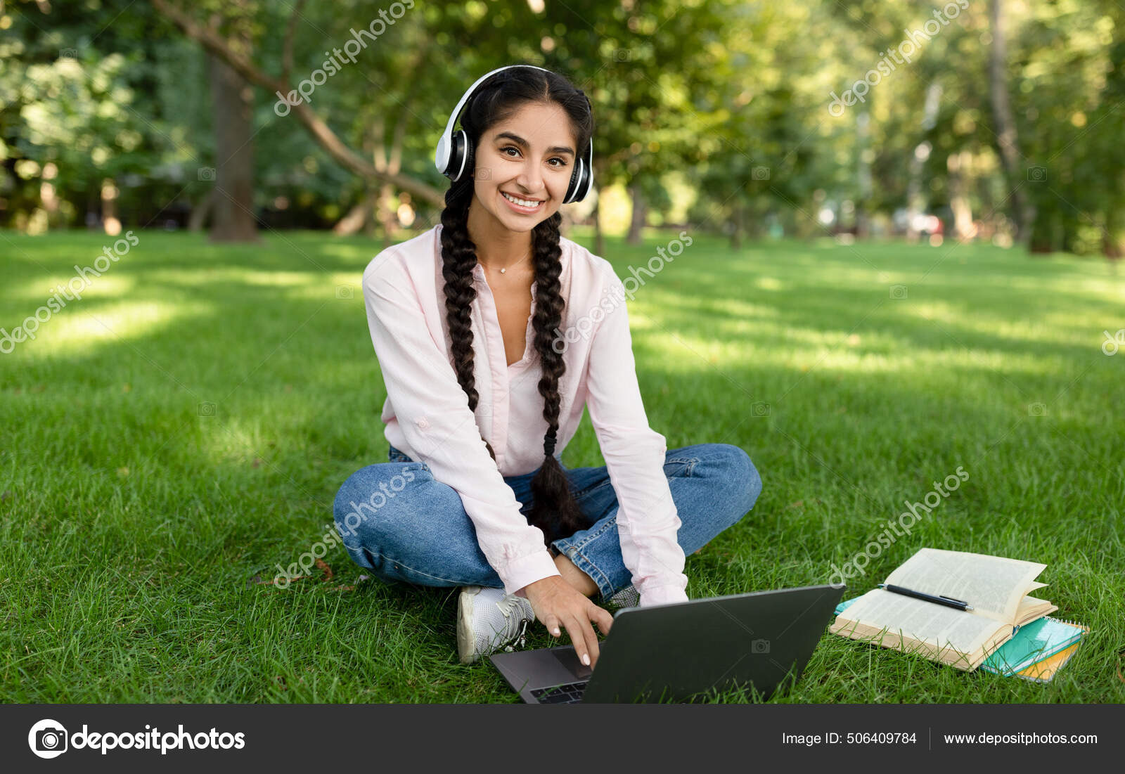 Indian student girl using laptop, learning in university campus ...