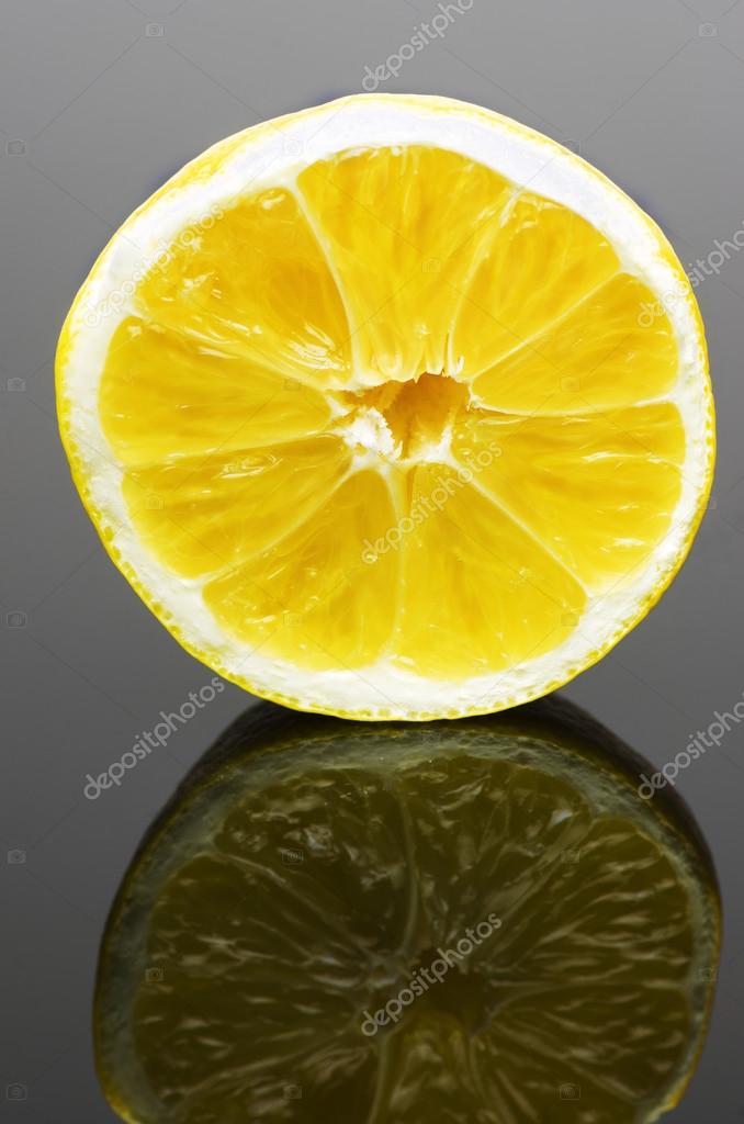 Single cross section of lemon. Isolated on black background. — Stock ...