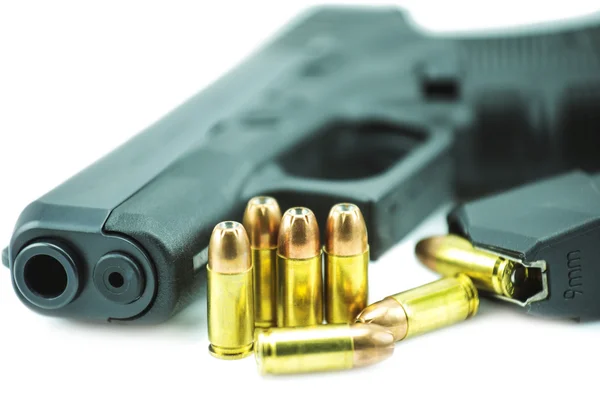 Handgun with ammunition on a dark wooden table. Sales of weapons and ...