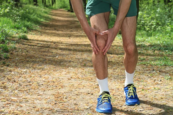 Runner holding sore leg, knee pain from running or exercising, j ...