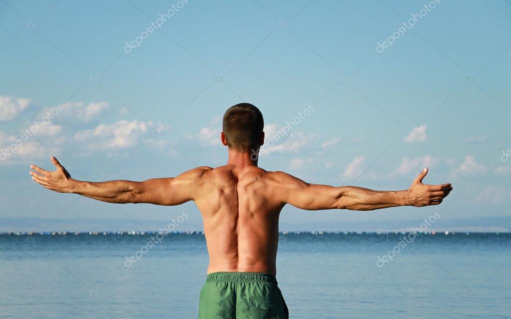 Man Raising His Hands or Open arms standing back looking to sea — Stock ...