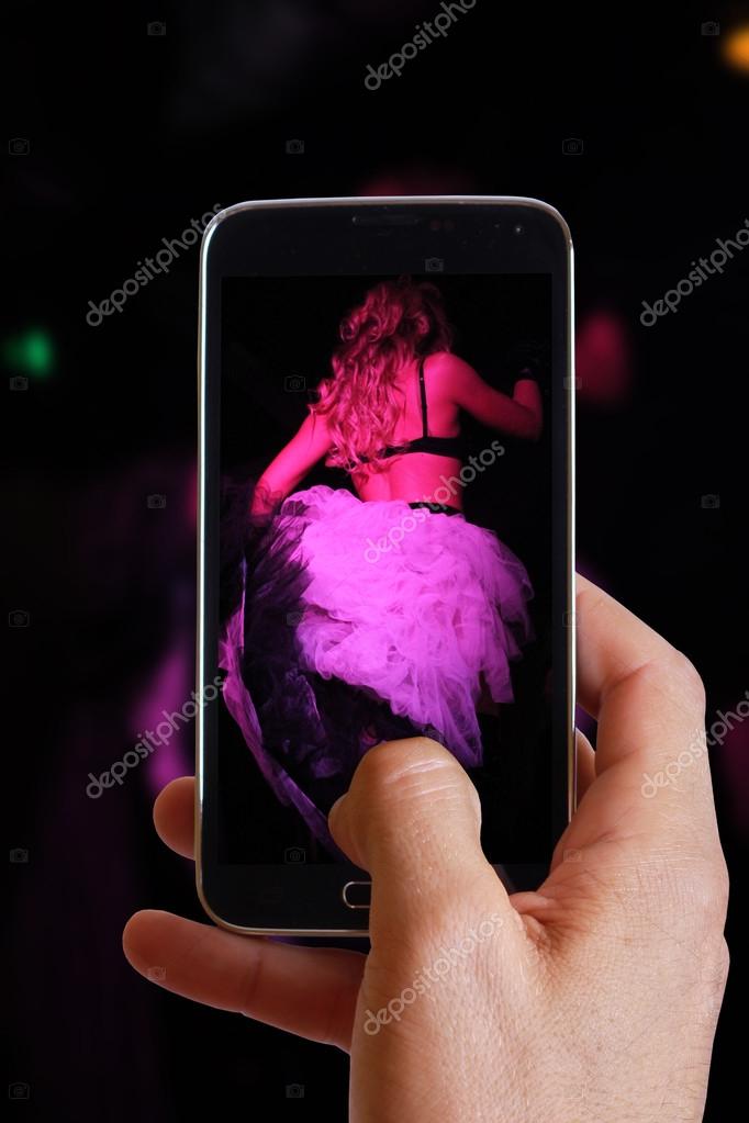 Male hand taking photo of exotic belly dancer with cell, mobile phone ...