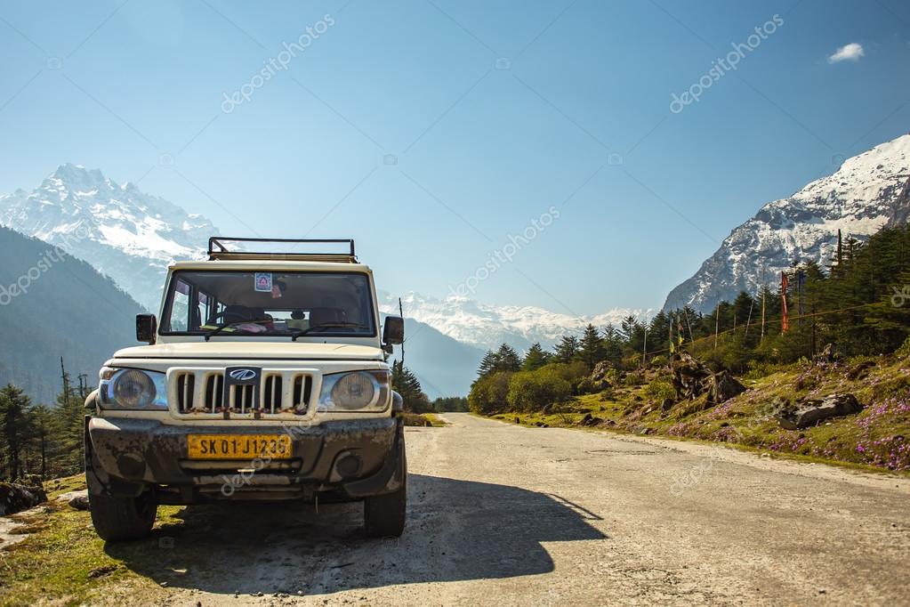 The Off Road car with snow moutain on background in Sikkim, Indi ...