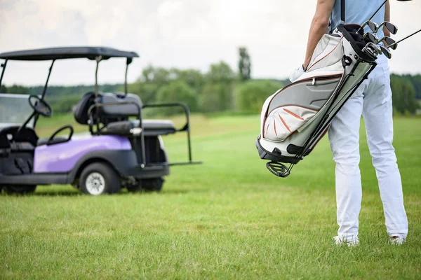 Golfer walking with golf bags - Stock Image - Everypixel