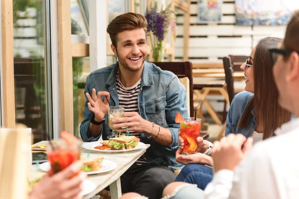 Happy friends having lunch in cafe Stock Photo by ©iakovenko123 116175350