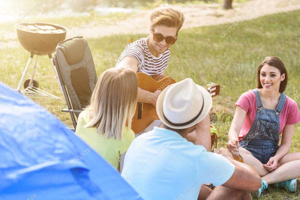 Young people having rest in camp Stock Photo by ©iakovenko123 116293934