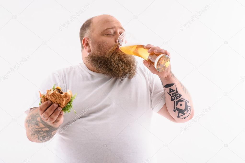 Thick guy drinking alcohol with snack Stock Photo by ©iakovenko123 ...