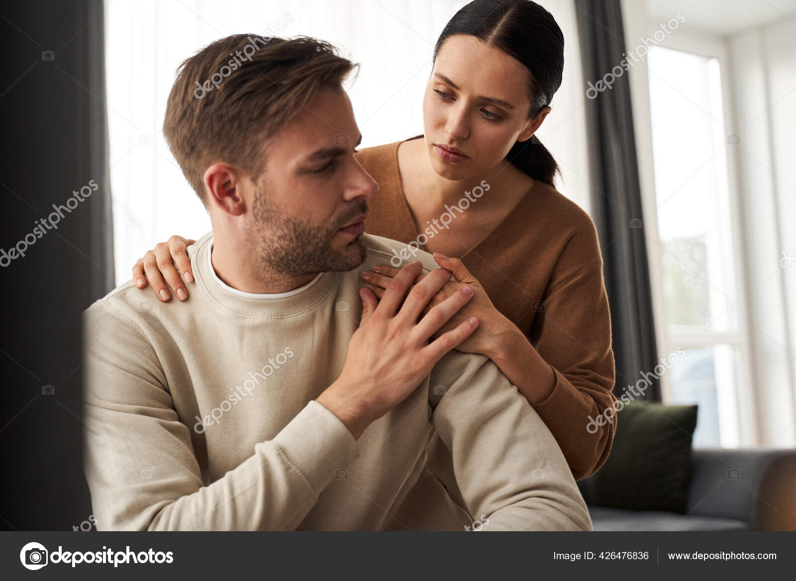 Wife caring and supporting to her upset husband Stock Photo by ...