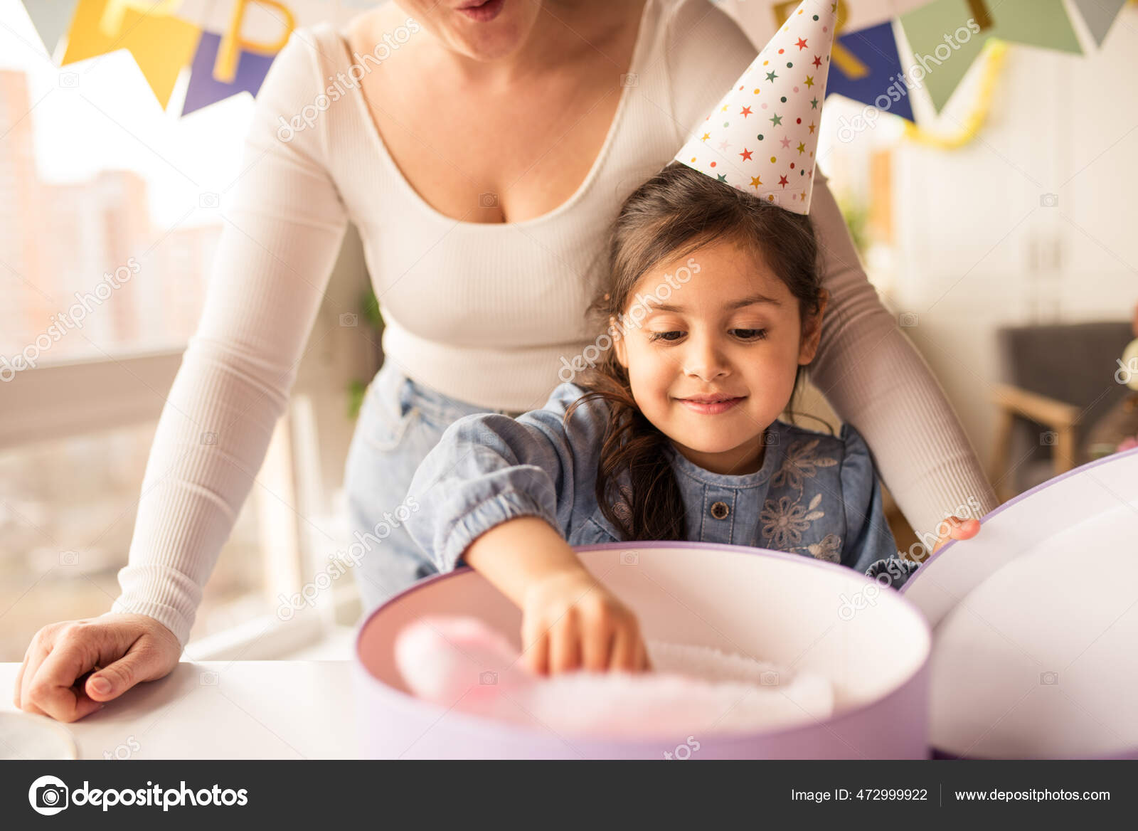 Girl taking something from the table while spending time with her ...