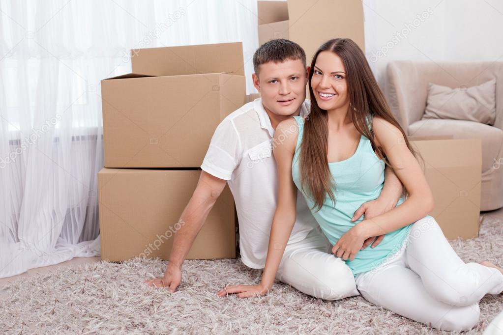 Cheerful young married couple is moving in another building Stock Photo ...