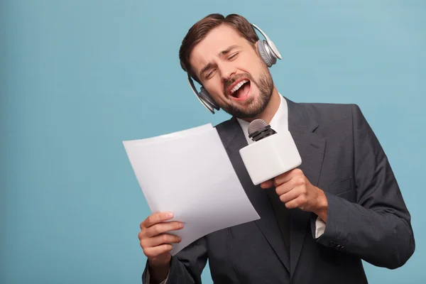 Attractive male reporter is making fun at studio - Stock Image - Everypixel