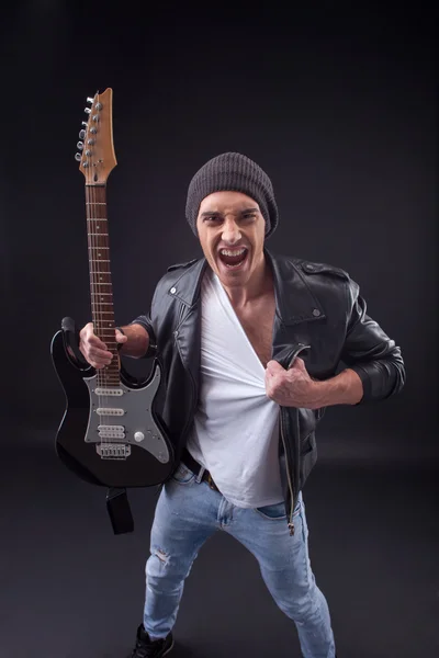 Cheerful young guitarist is making great entertainment Stock Photo by ...