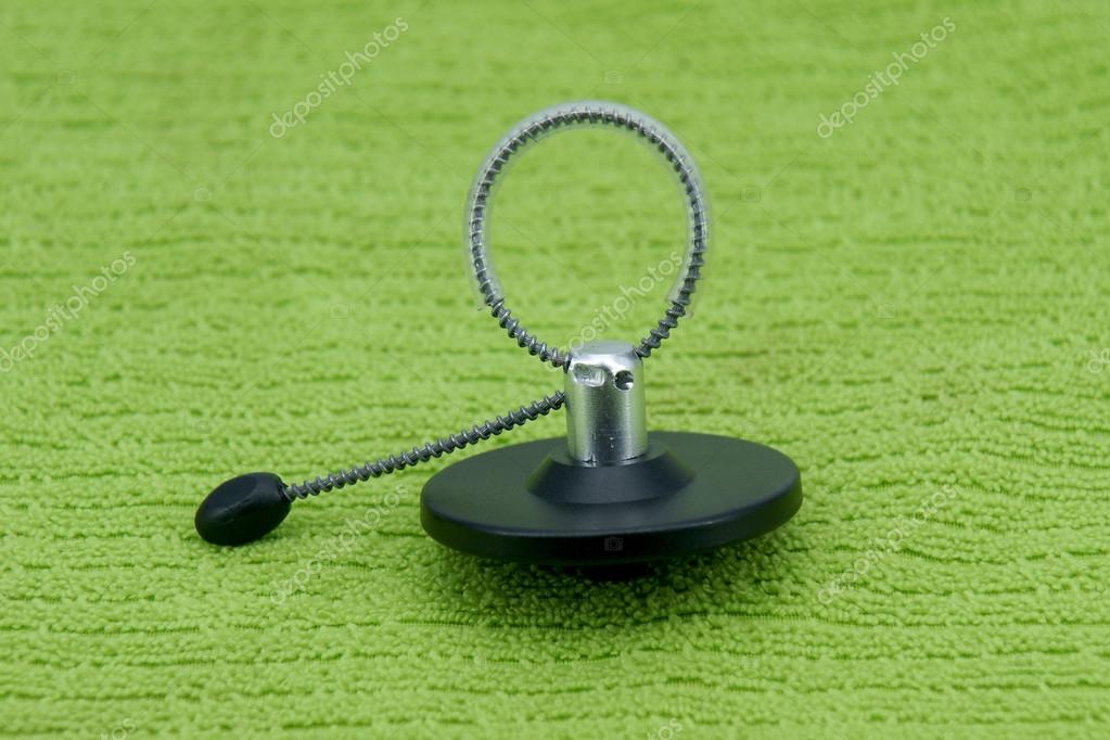 Magnetic bottle security tag on a green fabric — Stock Photo © Just_One ...