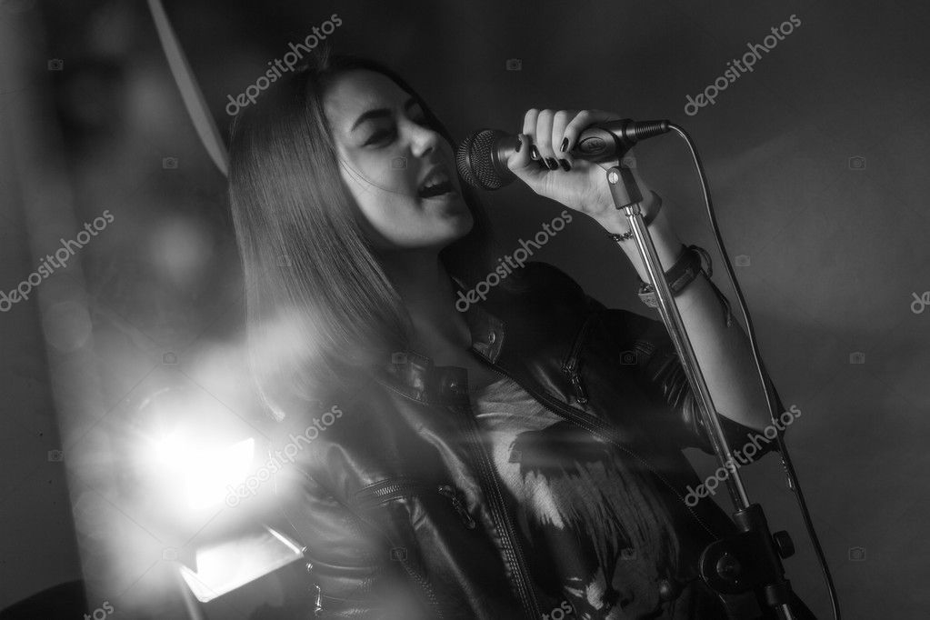 Girl singing into a microphone in a studio — Stock Photo © Edinorog12 ...