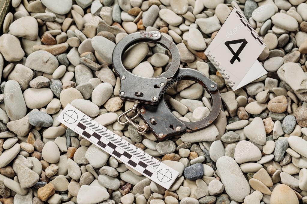 Crime scene investigation. Handcuffs dragged along outdoors Stock Photo ...