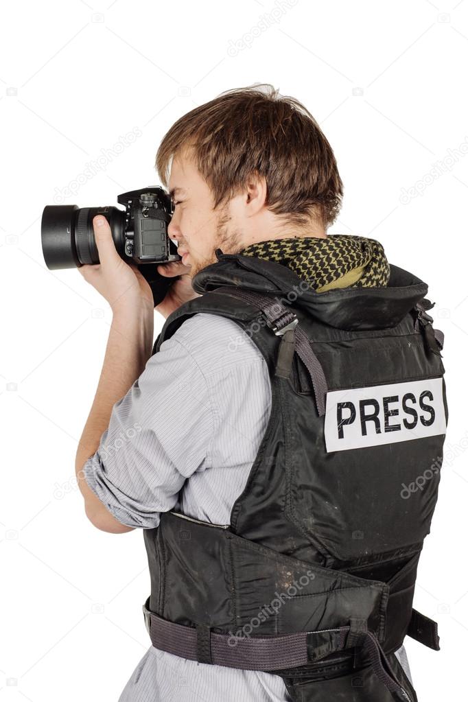Press photographer wears a protective vest and takes photos with ⬇ ...