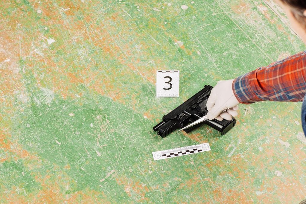 Criminalist preventing gun at the murder scene — Stock Photo ...