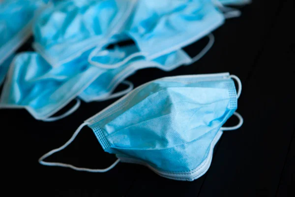 Used blue surgical protective masks. Pollution by surgical masks during ...