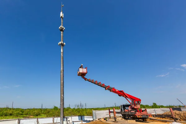 Engineer starts working on the telecommunication tower -cellular phone ...