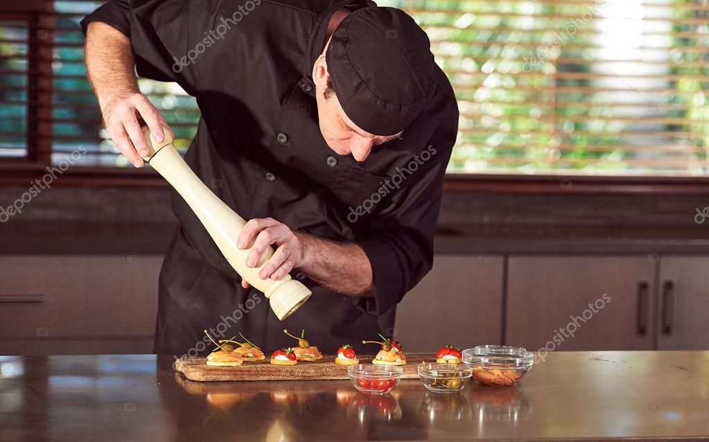 Chef preparing canapes — Stock Photo © geoffgoldswain #121525700