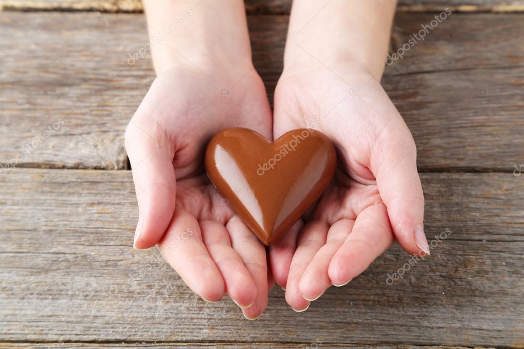 Woman's hands with chocolate heart — Stock Photo © 5seconds #70590061
