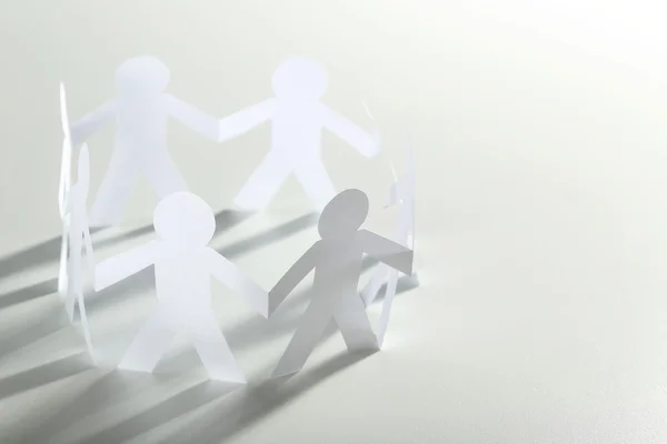 Paper chain people with female hands on white background — Stock Photo ...