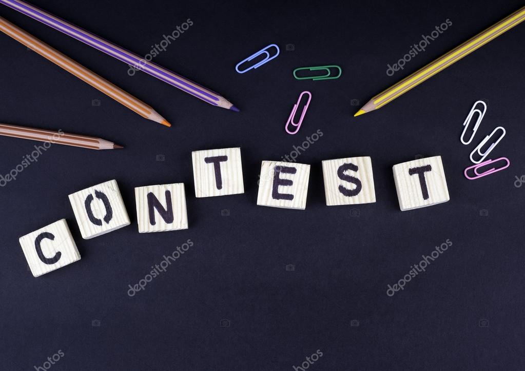 Contest. Text from wooden letters on a black office desk. Stock Photo ...