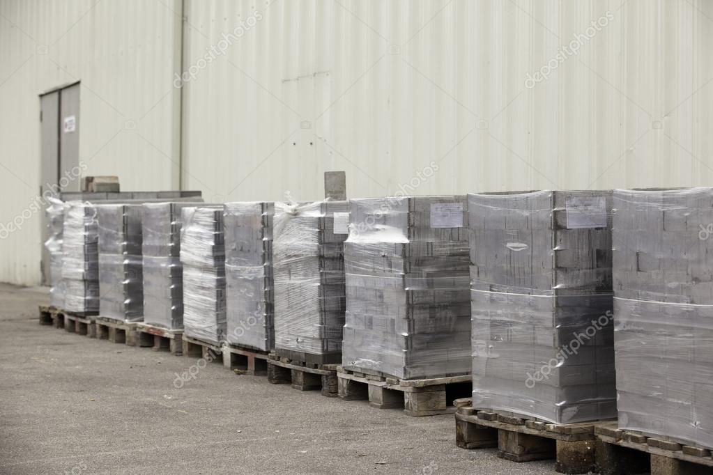 Cobblestone wrapped in plastic paving on wooden pallets Stock Photo by ...