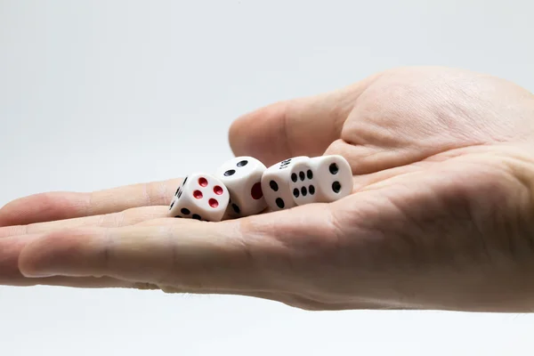 Human hand ready to roll the dice on white isolated background - Stock ...