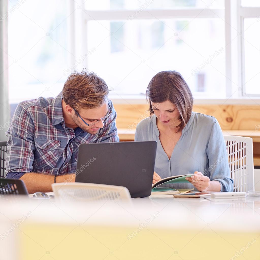 Man and woman working together in office Stock Photo by ...