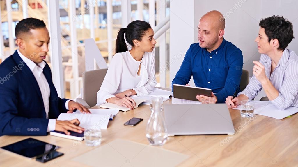 Business people busy conducting meeting Stock Photo by ©NakoPhotography ...