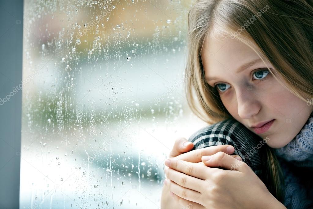 Sad Girl Looking Out Rainy Window