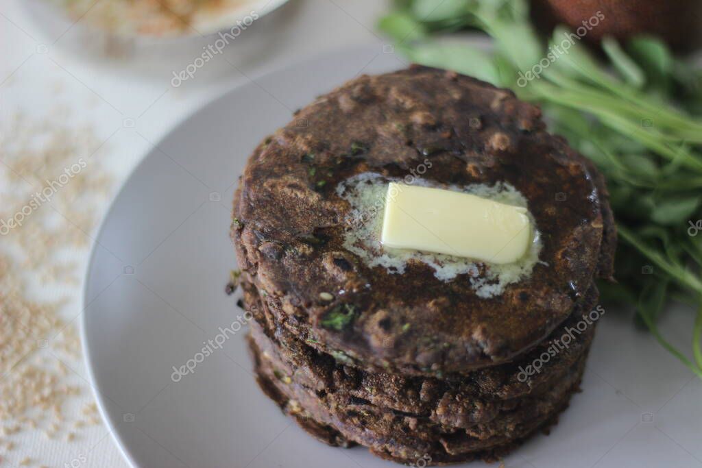 Pan plano con mijo de dedo y hojas de alholva servidas con cuajada de ...