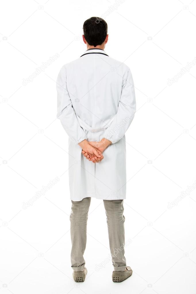 Full length backside view of a male doctor with hands behind his back ...