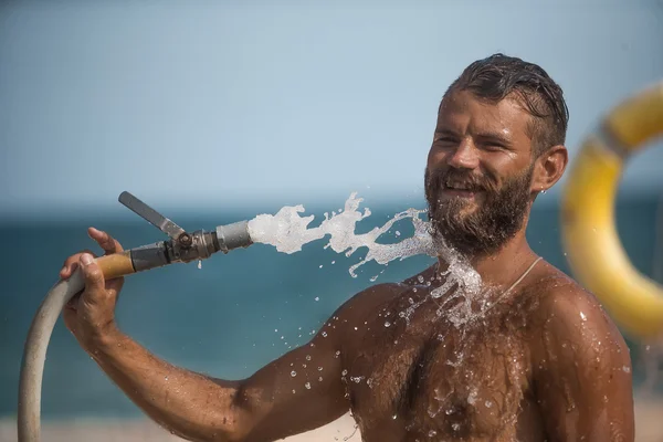 Man with hosepipe Stock Photos, Royalty Free Man with hosepipe Images ...