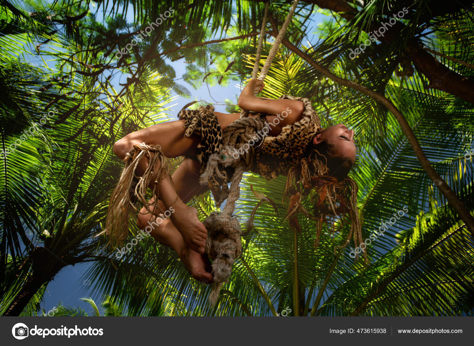 Female Tarzan Wearing Leopard Fur Swinging Rope Jungle — Stock Photo © korolOK #473615938