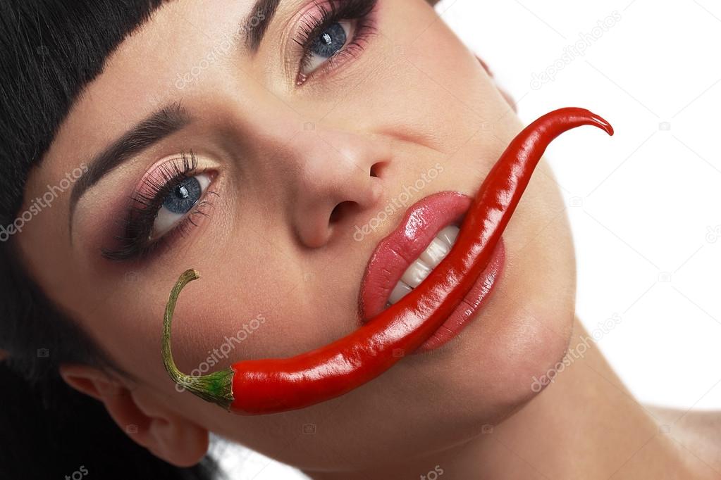Lady holding chilli pepper — Stock Photo © korolOK #73348387