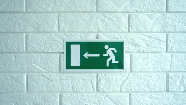 Exit emergency sign in 4K slow motion. An exit sign hangs on a wall. 4k ...