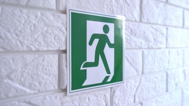 Exit emergency sign in 4K slow motion. An exit sign hangs on a wall. 4k ...